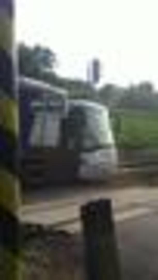 School Bus Gets Stuck Dangerously Close to Railway Tracks as Train ...