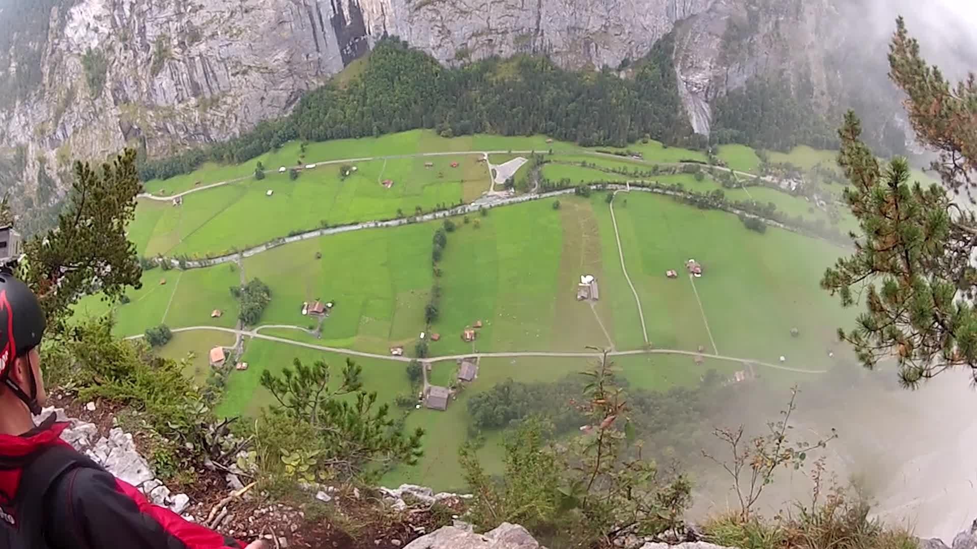 BASE Jump Off Rock Cliff to Country Village | Jukin Licensing