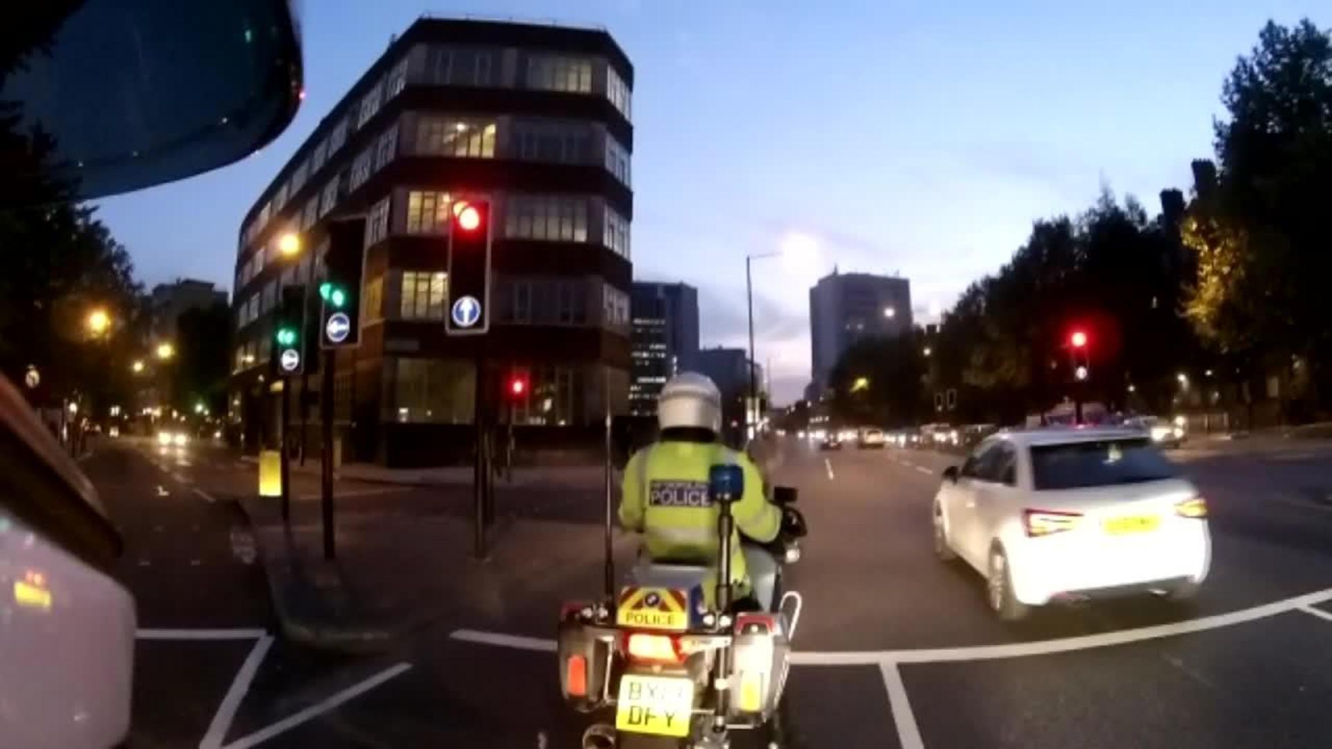 Car Runs Red Light in Front of Police Officer | Jukin Licensing