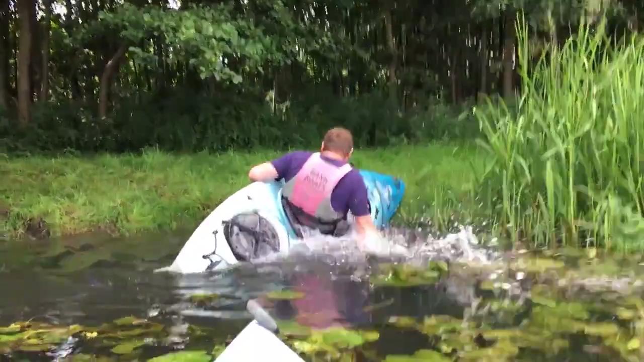 Women Fall Into Lake While Doing Yoga on Paddleboard | Jukin Media Inc