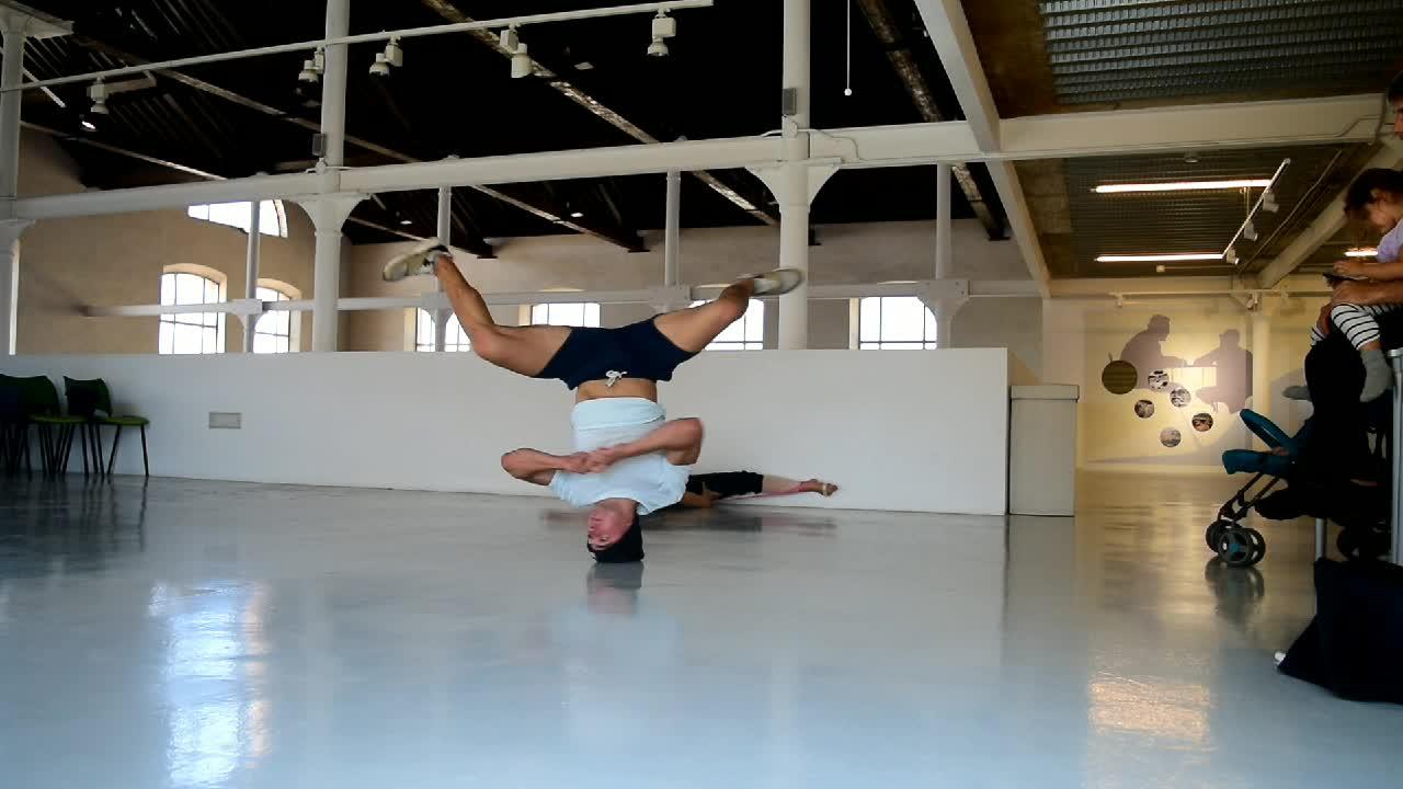 Breakdancer Spins on Head in Front of Crowd on Street | Jukin Media Inc