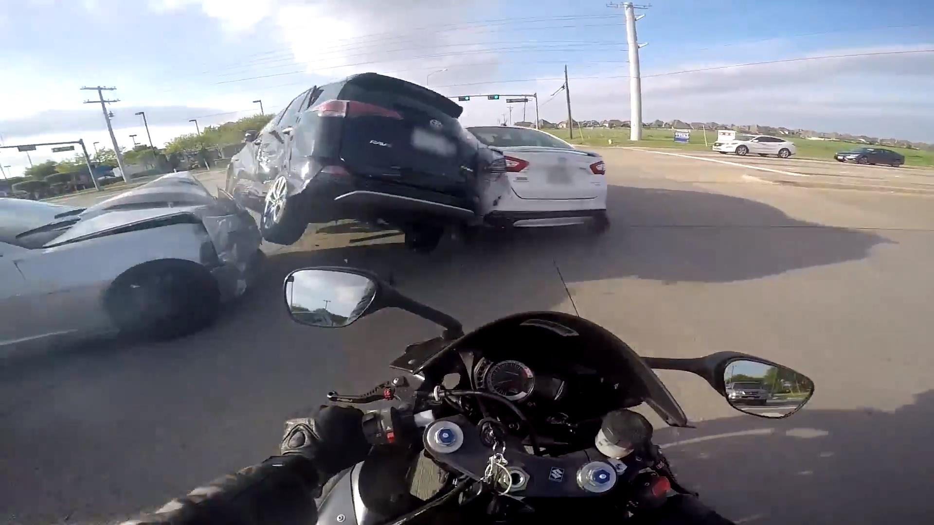Motorcyclist Crashes and Slides Between Wheels of Semi | Jukin Media Inc
