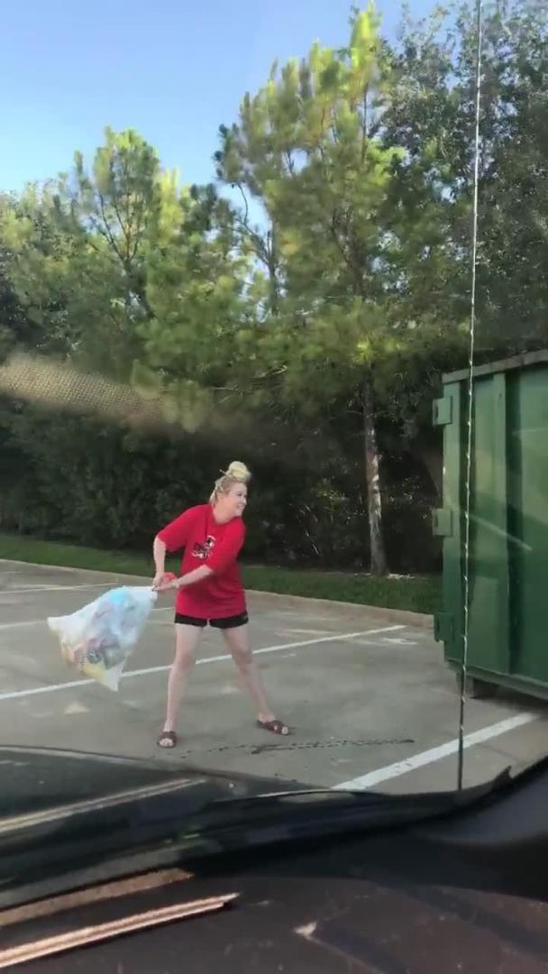 Woman Accidentally Breaks Garbage Bag Outside Dumpster | Jukin Licensing