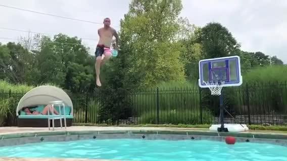 Man Slam Dunks While Jumping into the Pool | Jukin Media Inc