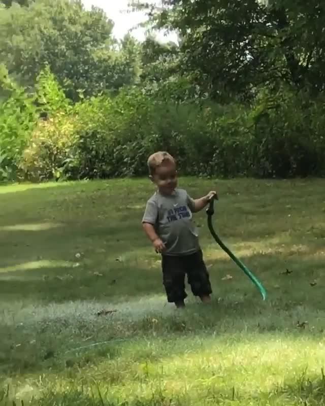Toddler Accidentally Sprays Self in Face with Garden Hose | Jukin Licensing