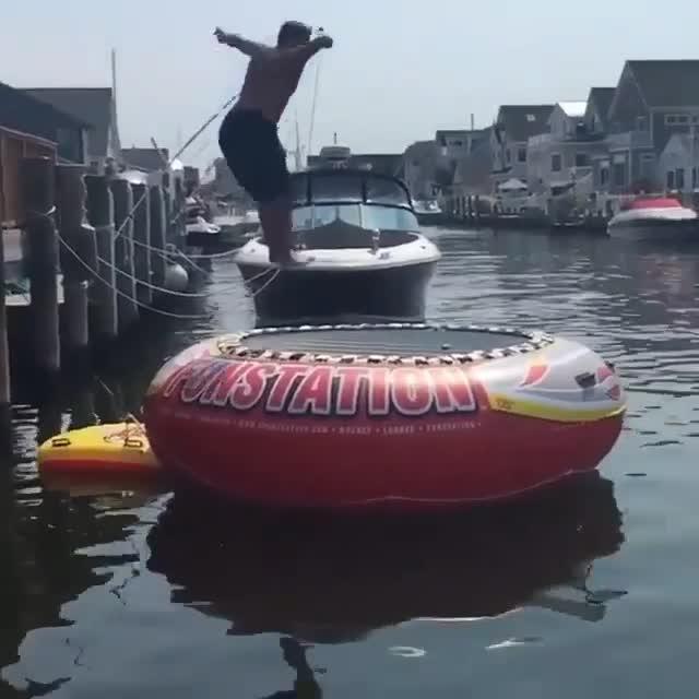 Guy Bounces off Inflatable Trampoline into Water | Jukin Licensing