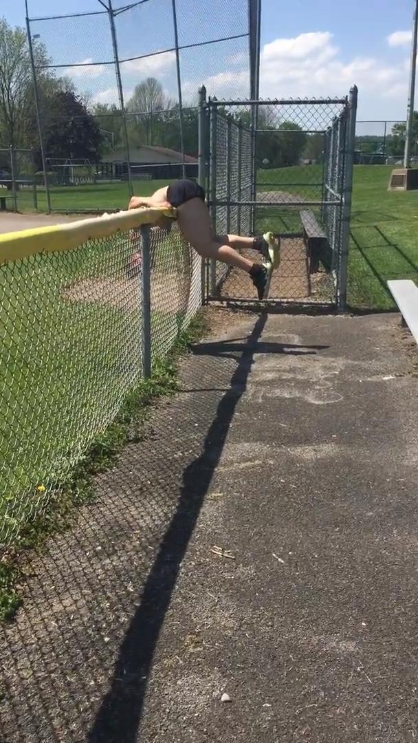 Guy Fails Squat Jump Over Fence and Lands on Stomach | Jukin Licensing