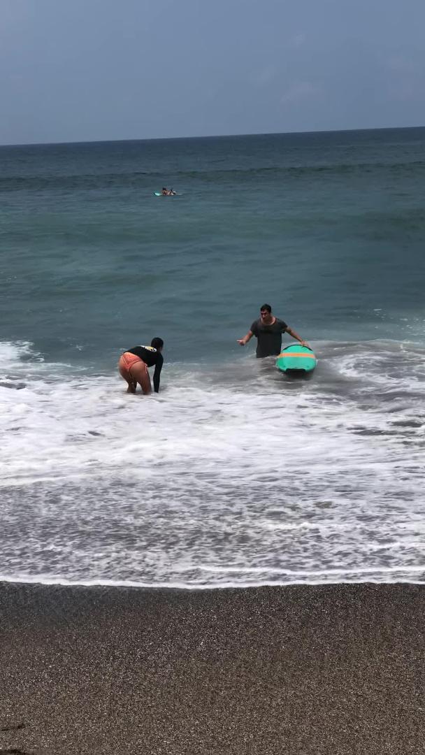 Female Surfer Gets Hit by Wave and Falls Backwards | Jukin Licensing