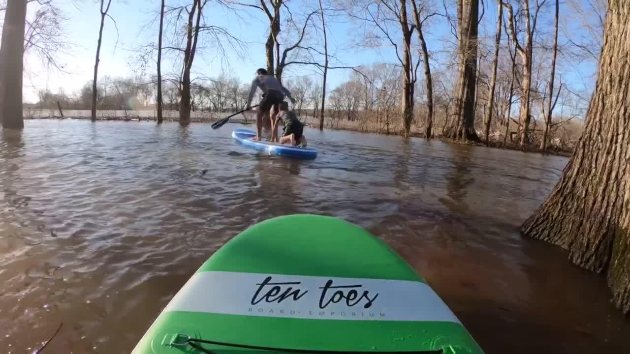 Father and Son Fall Off Paddleboard into Flooded River | Jukin Licensing