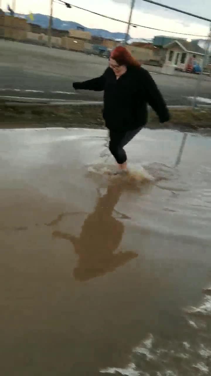 Woman Running in Water Puddle Falls Awkwardly | Jukin Licensing