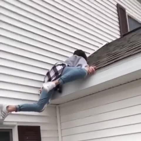 Girl Attempting to Climb on Roof Falls Down | Jukin Licensing