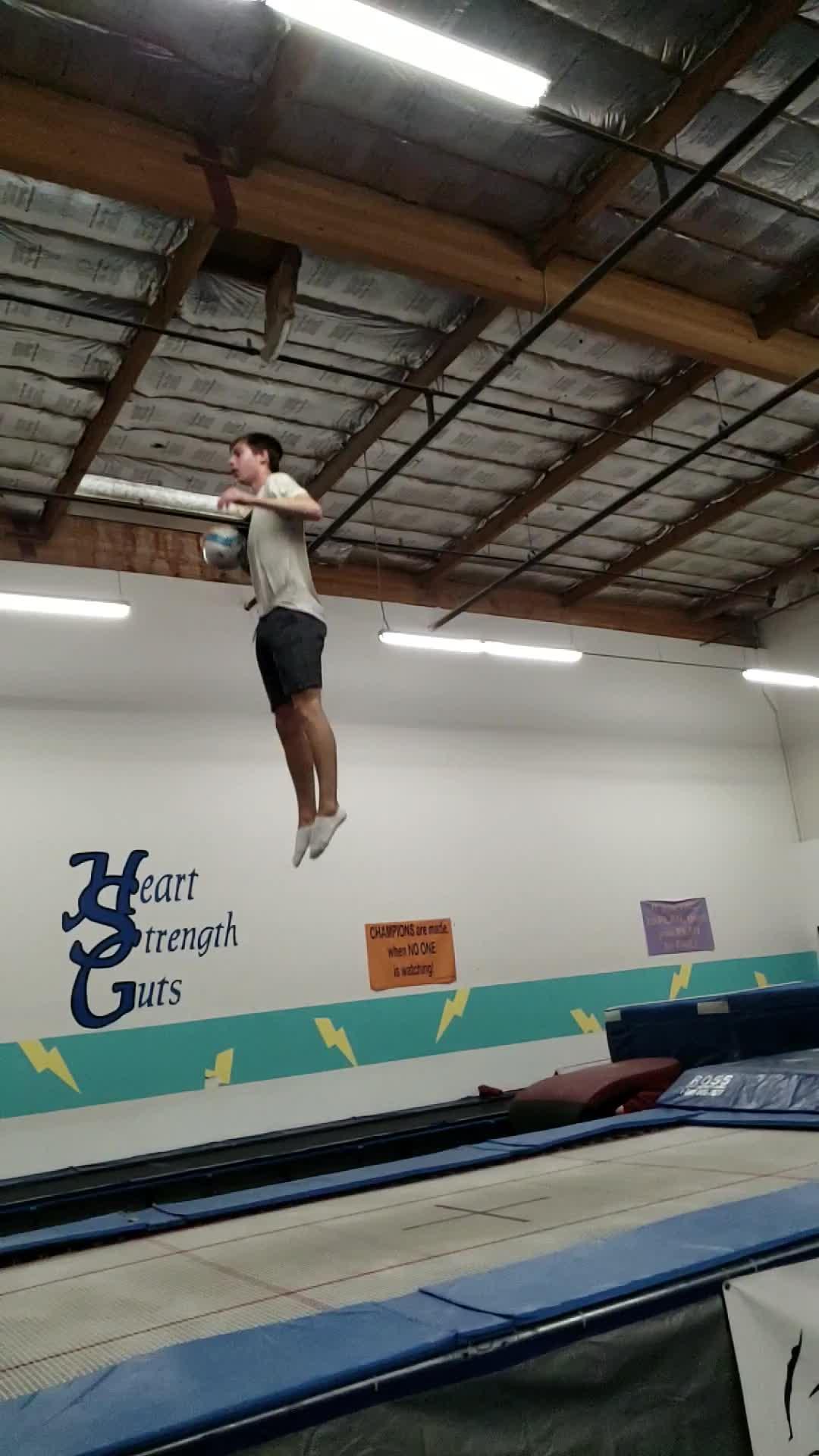Guy Does Mid Air Flip Trick with Ball While Jumping on Trampoline ...