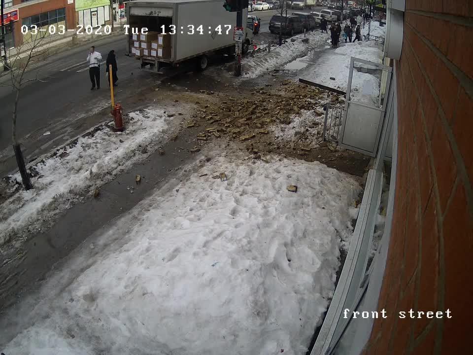 Woman has Narrow Escape as Bricks Fall Off Building | Jukin Licensing