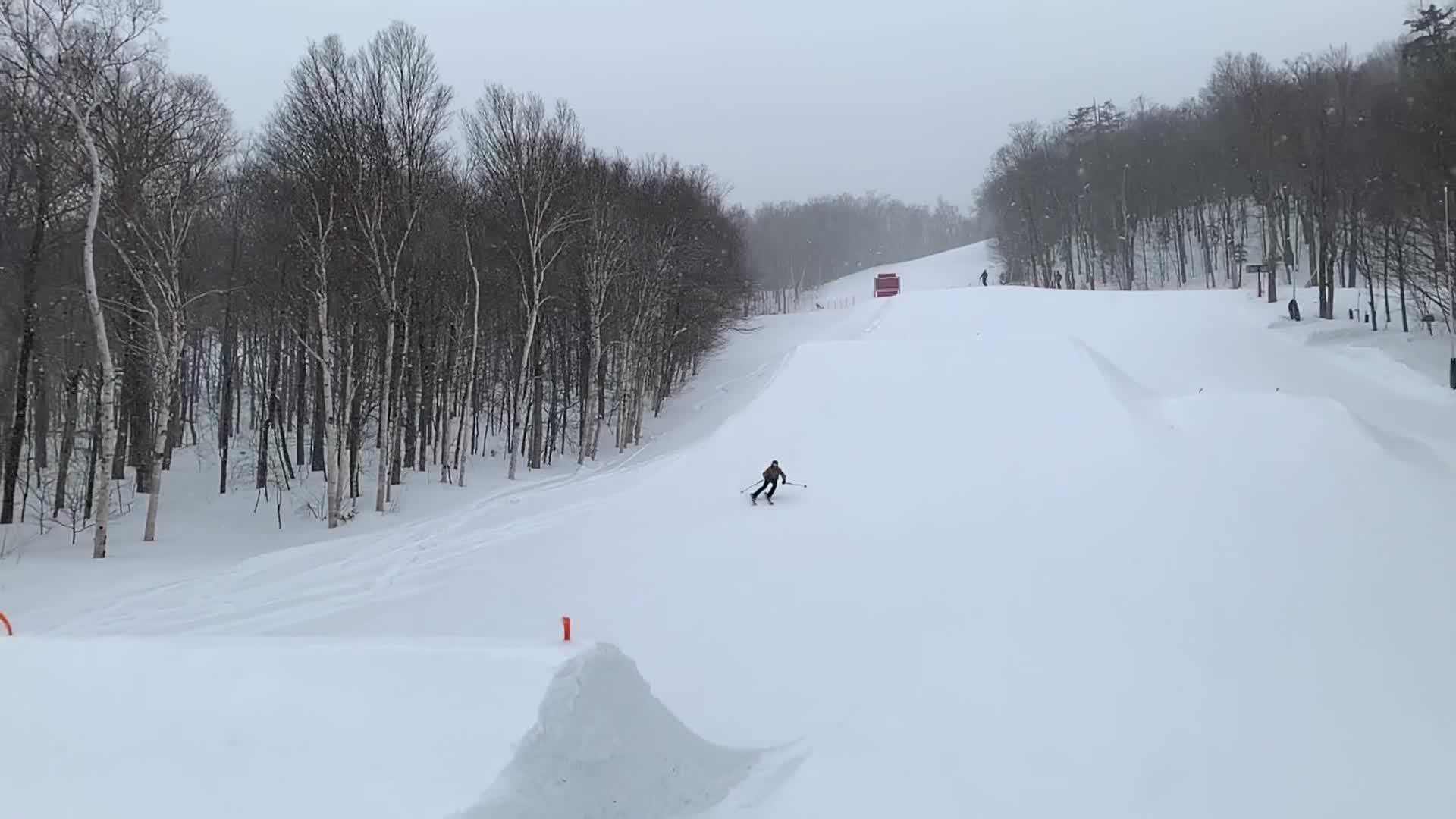 Group of Skiers Jump off Snow Ramp Doing Flips Together | Jukin Media Inc