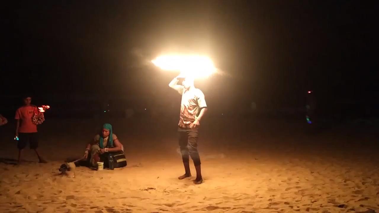 Young Boy Performs Amazing Fire Stunts at an Indian Beach | Jukin Licensing