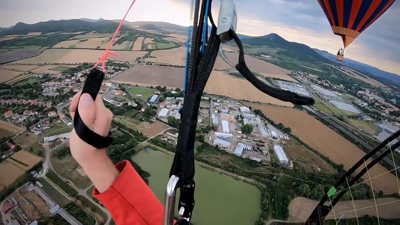 Guy Enjoys Sunset While Paragliding Around Hot Air Balloon | Jukin ...