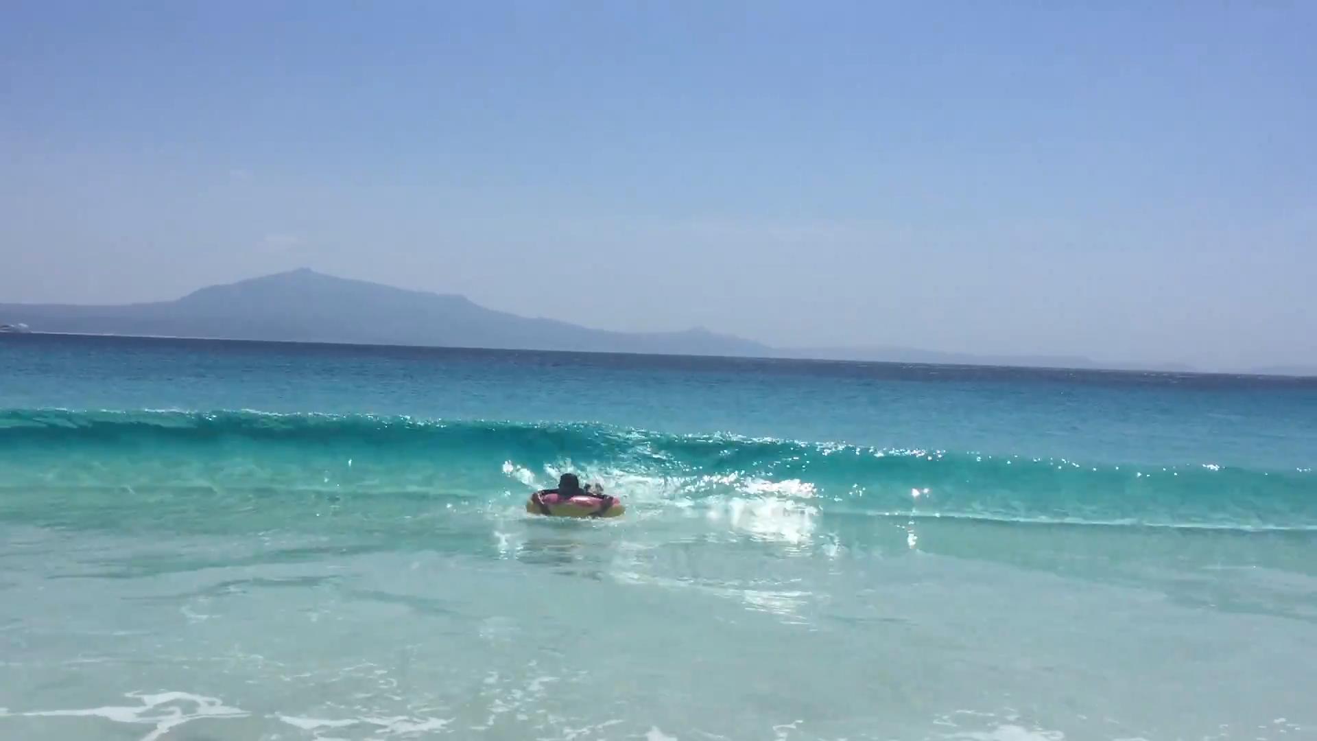 Guy Gets Hit By Wave While Floating on Swim Ring | Jukin Licensing