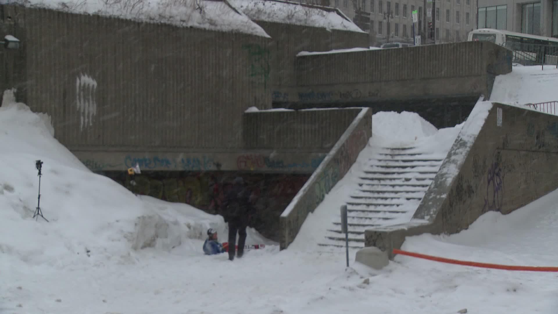 Skier Lays in Snow After Falling off Ledge and Pedestrian Walks Over ...
