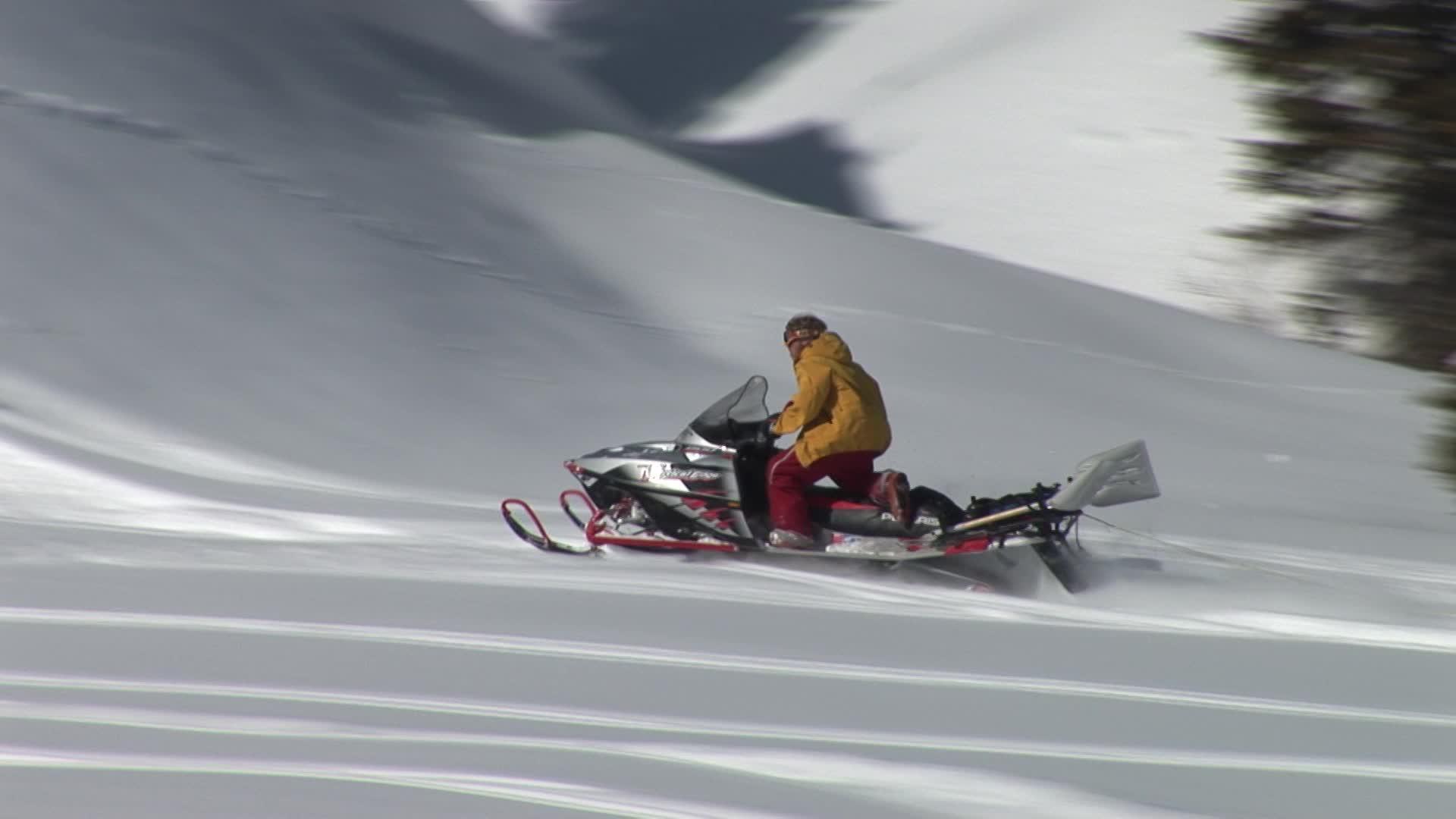 Guy Falls Off Snowmobile While Riding Bumpy Hills | Jukin Licensing