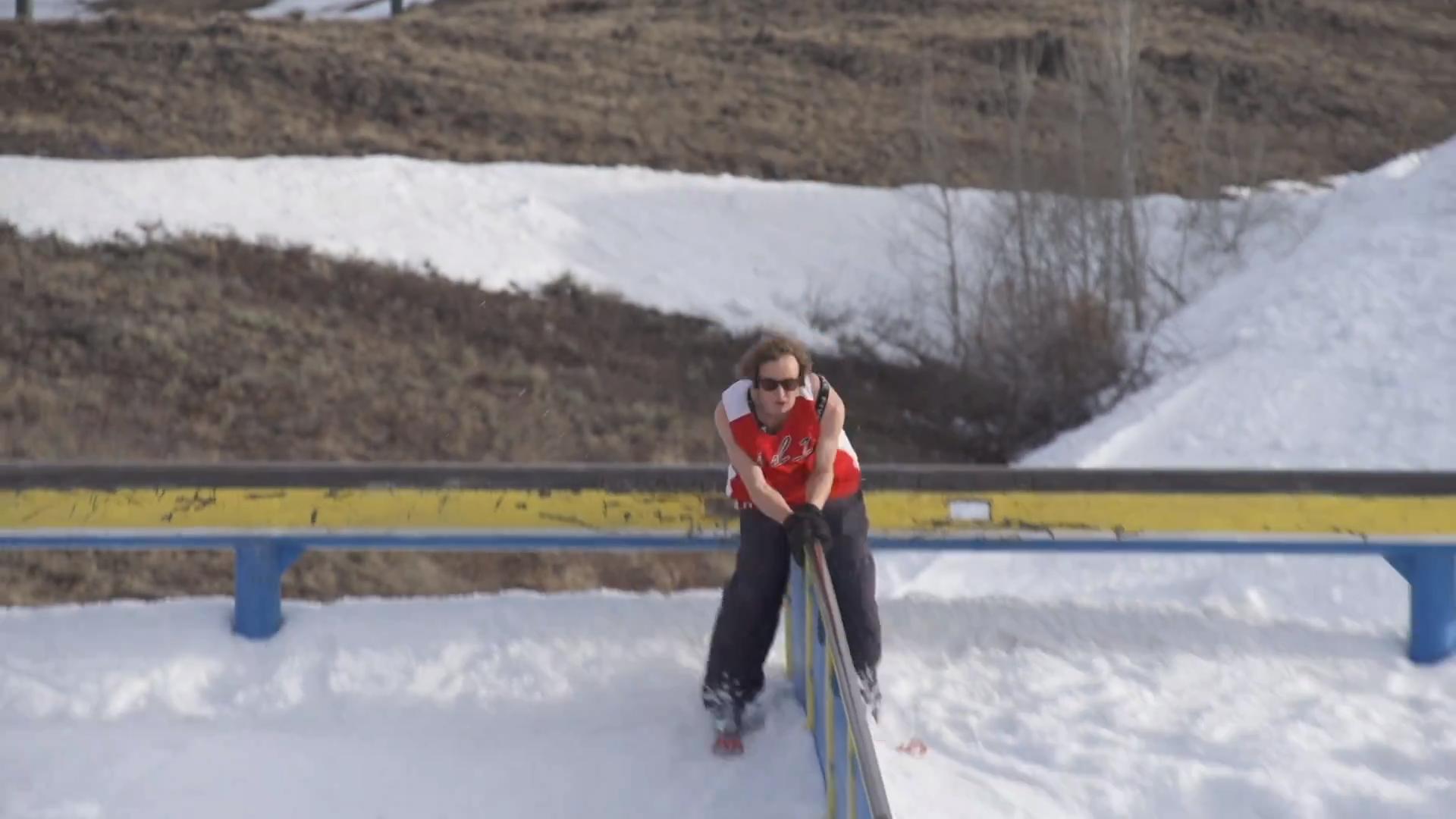 Guy Skis on Rail With Legs Apart on Either Side | Jukin Licensing