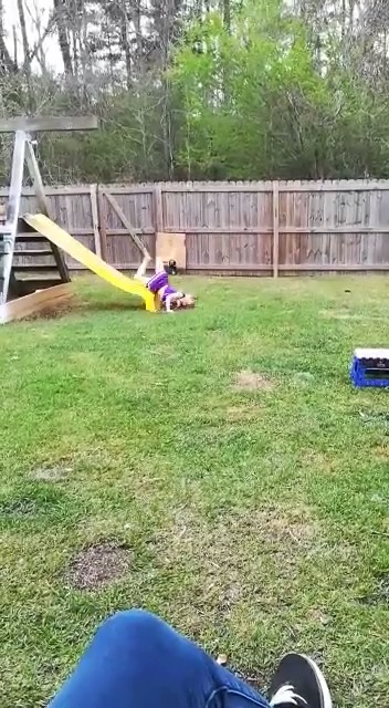 Little Girl Falls Off Slide While Playfully Putting up Cheerleading ...