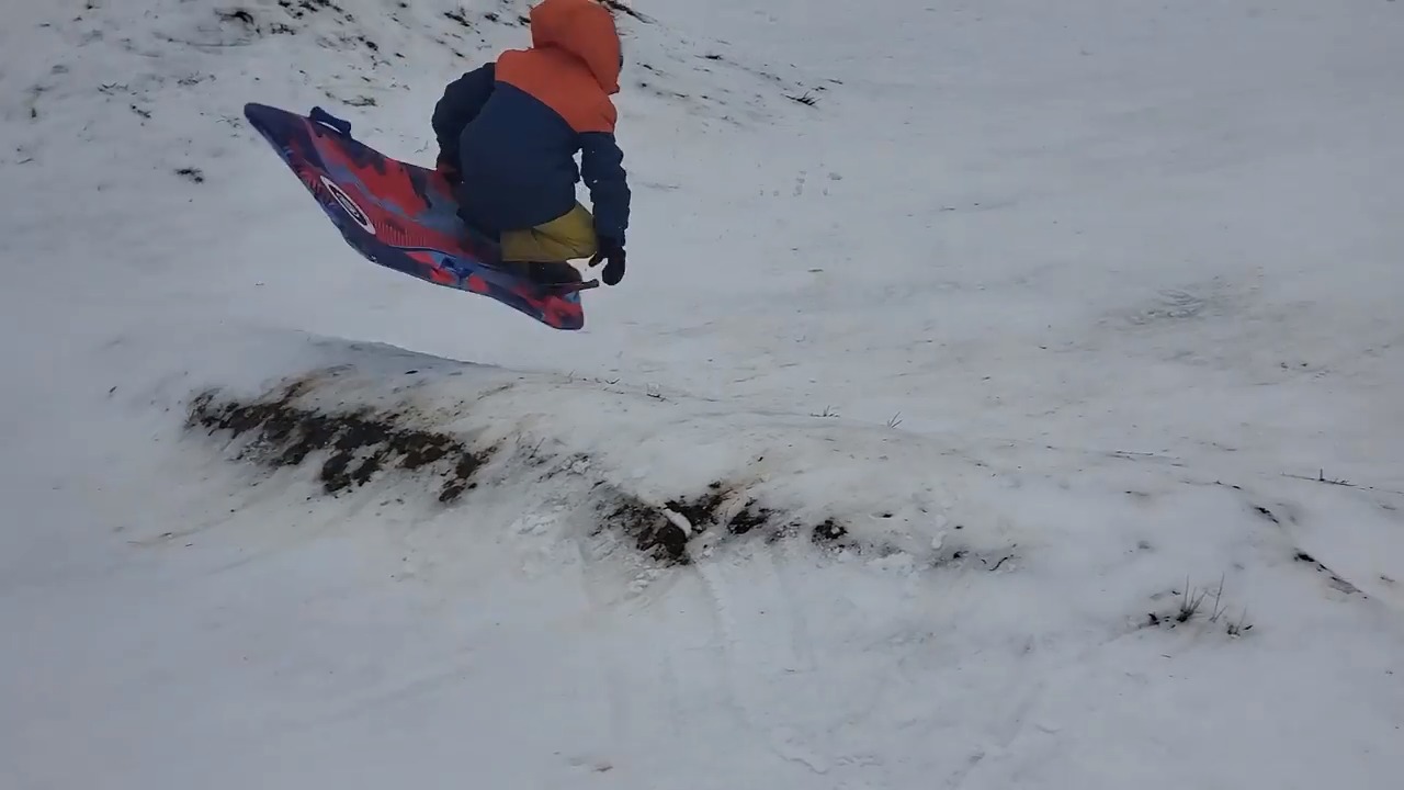 Sledding Kid Falls Off Sled After it Hits Bump | Jukin Licensing