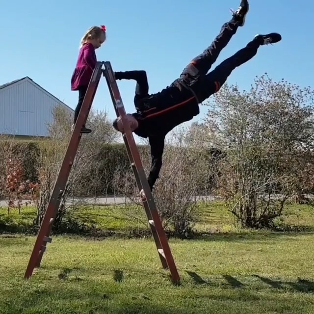 Guy Stands on Ladder while Balancing Tablet on Face | Jukin Media Inc