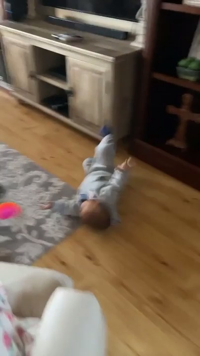 Toddler Slips and Falls Over Backwards While Running Around Holding ...