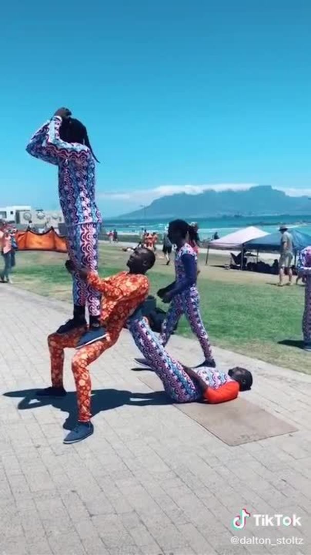 Group Of People Show Amazing Balance Skills While Performing Acro Yoga ...