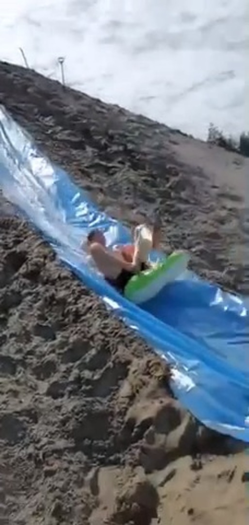 Guy Falls Headfirst Into Water While Going Down Hill on Slip 'N Slide ...