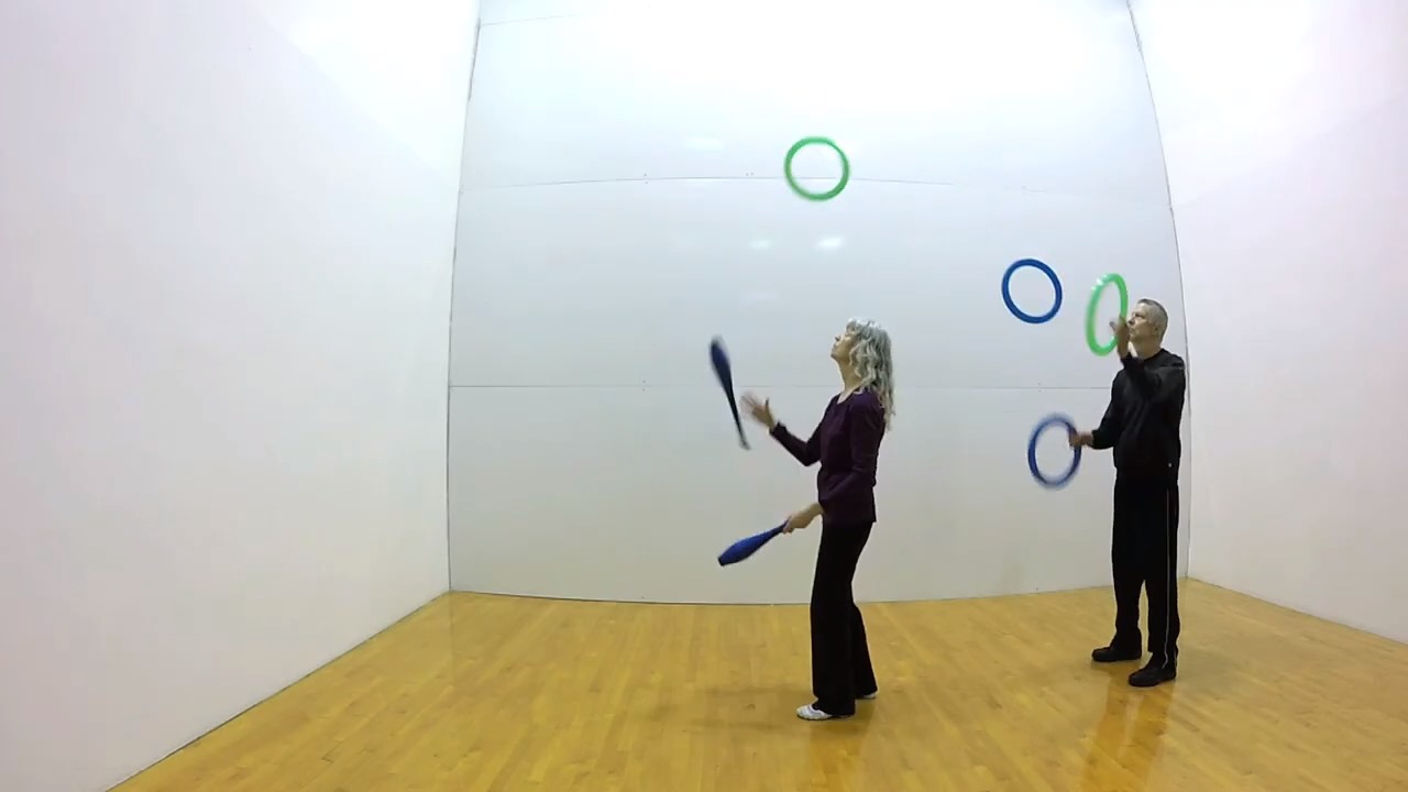 Woman Bounces Rings Off Wall While Performing Pass Juggling Trick With ...