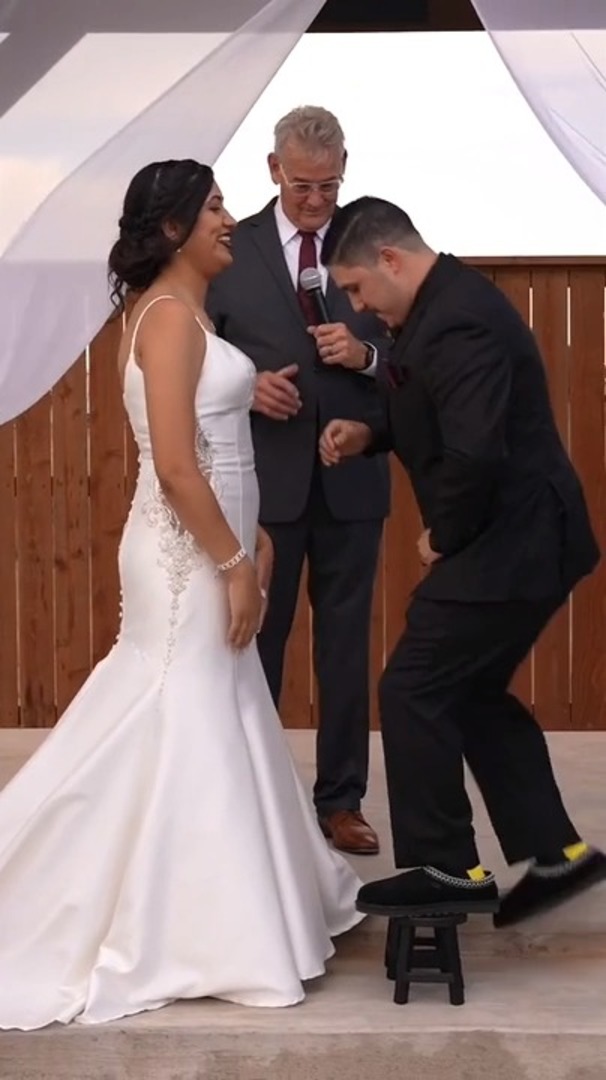 Man Stands Upon Small Stools To Step Up And Kiss Bride During Wedding ...