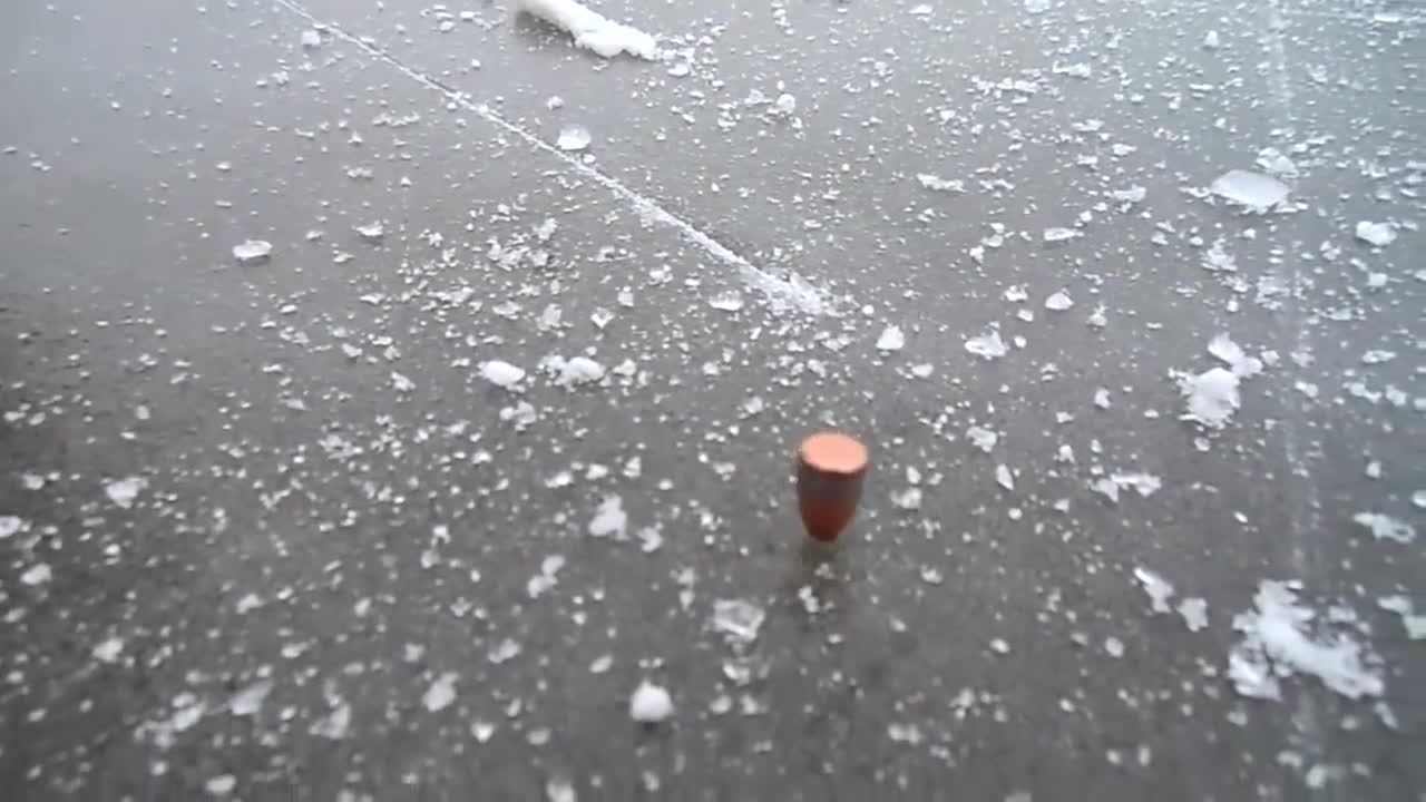 Bullet Spins In Fast Motion On Ice After Man Shoots It Towards Frozen ...