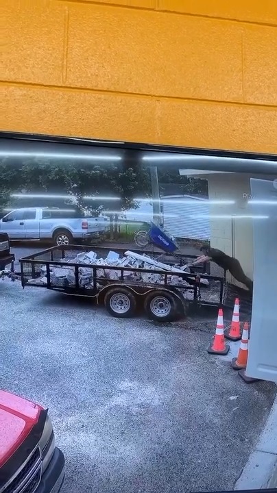 Guy Slips and Falls While Dumping Rubble Into Cart Using Wheelbarrow ...