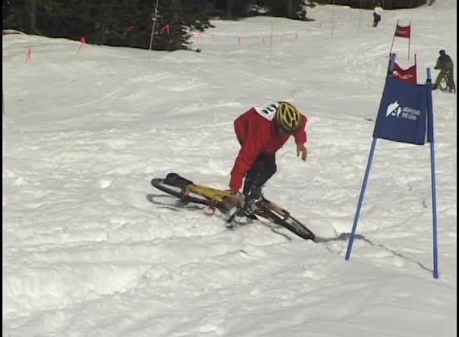 Rider Struggles to Maintain Balance While Riding Downhill on Snowy ...