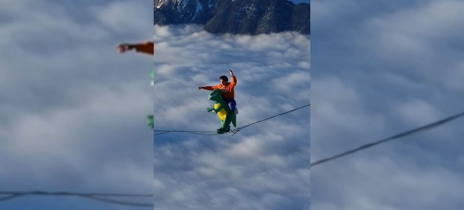 Man Walks on Highline While Wearing Inflatable Ride-On Dinosaur Costume ...