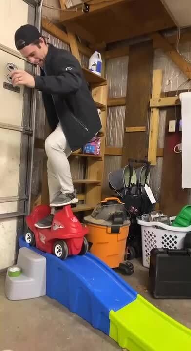 Guy Attempts to Ride Children's Toy Down Toy Ramp and Falls Down ...