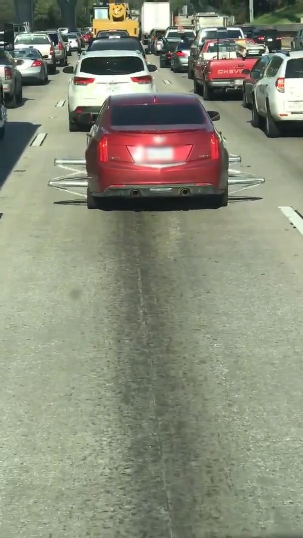 Car With Protruding Wire Rims Drives Down Highway | Jukin Licensing