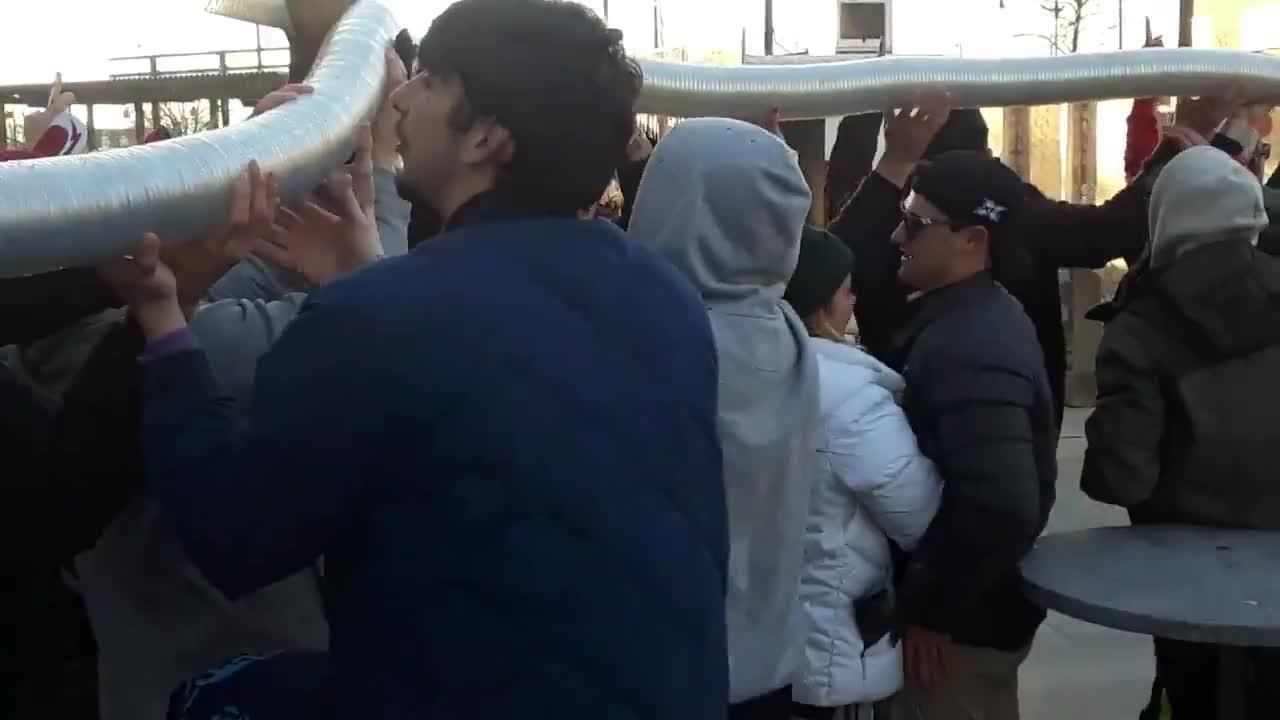 Crowd of People Amazingly Carry Big Snake Made of Cups on Shoulders ...