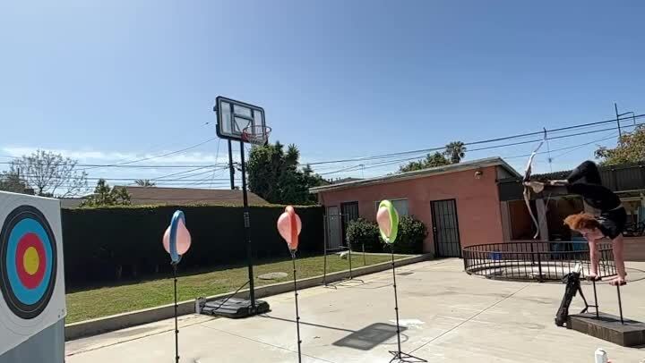 Foot Archer Doing Handstand Hits Target Steering Through Three Hurdles ...