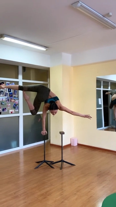 Yoga Champion Performs Leg Movements While Balancing Upside Down on ...