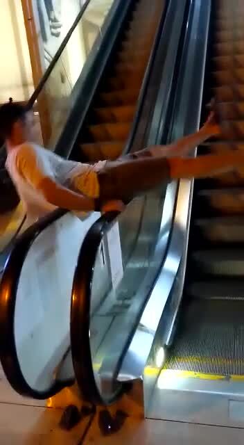 Guy Falls Off Escalator While Trying to Lie Down on Handrail | Jukin ...
