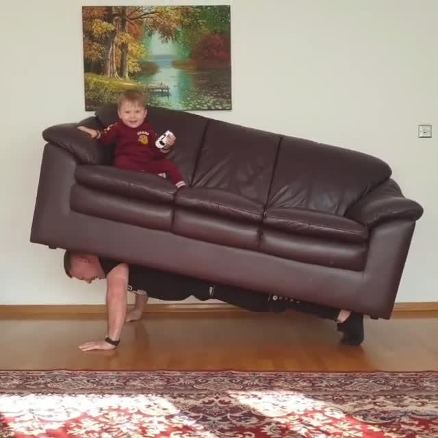 Man Does Push Ups While Lifting Couch with Toddler Seated on his Back ...