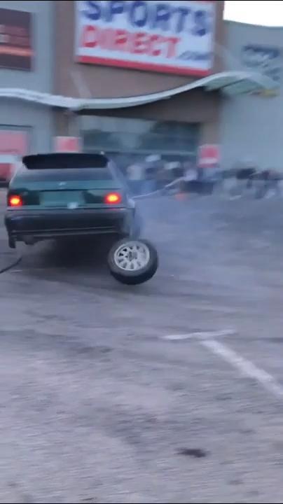 Tire Comes Loose While Driver Shows Off Donut Stunt in Car in Front of ...