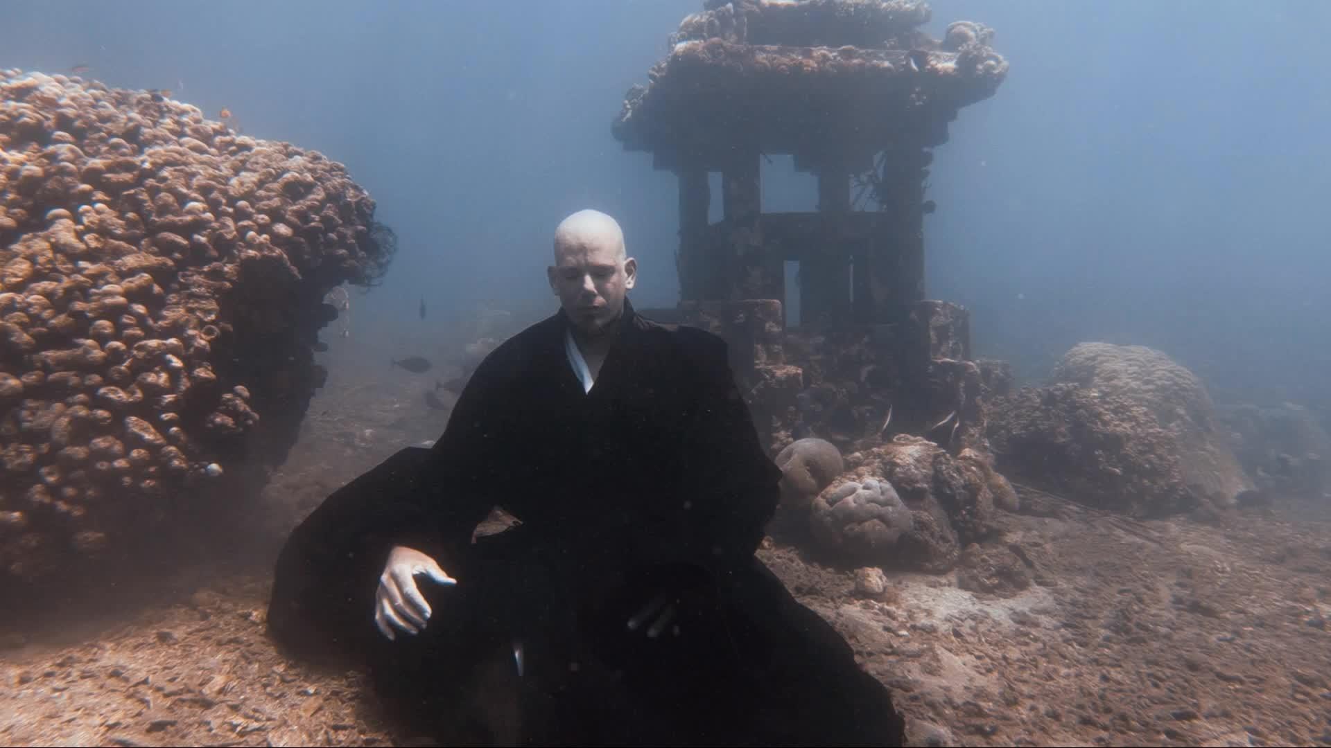 Monk Meditates Next to Underwater Ruins | Jukin Licensing