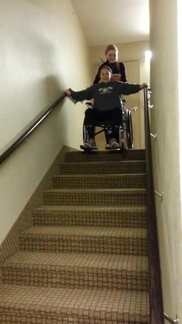 Girl Crashes Going Down Stairs in Wheelchair | Jukin Licensing