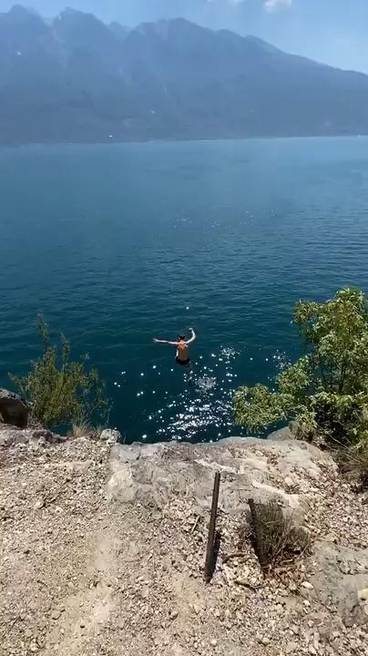 Guy Jumps Off High Cliff and Dives Into Water | Jukin Licensing