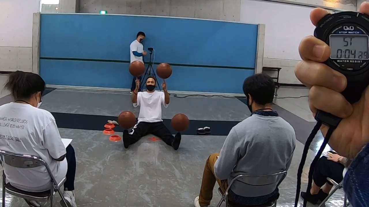 Freestyle Basketball Player Balances Four Balls on Fingers and Toes ...