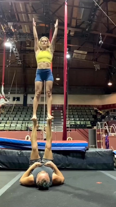 Acro Yoga Performer Flips Acrobat With His Feet While Lying on His Back ...