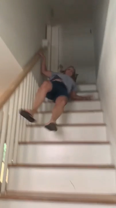 Mom Slips And Falls Down Wooden Stairs While Person Gives House Tour ...